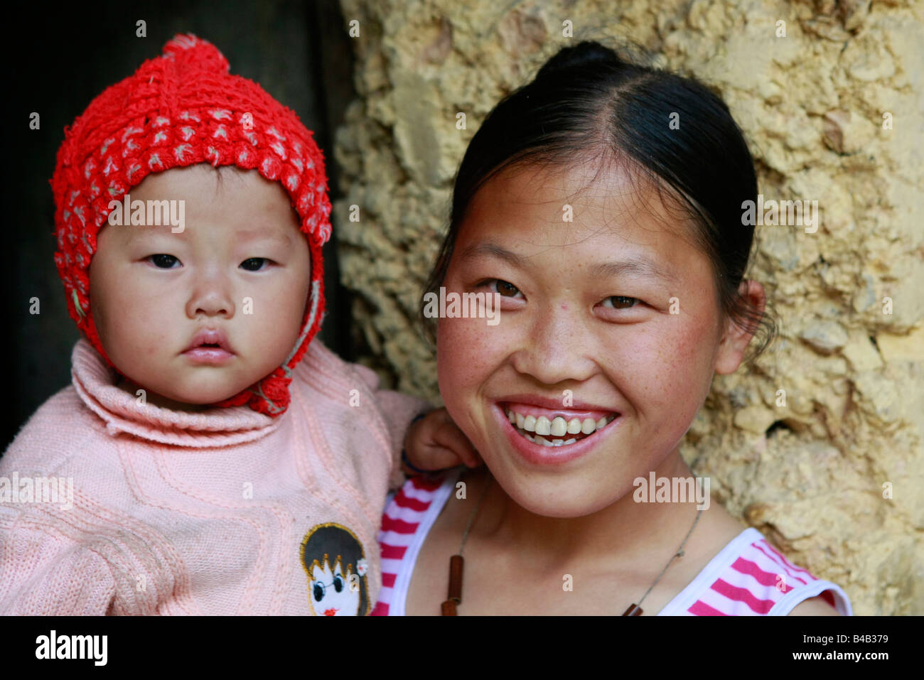 White Hmong tribeswoman and child at the village of Pho Lao, Dong Van ...