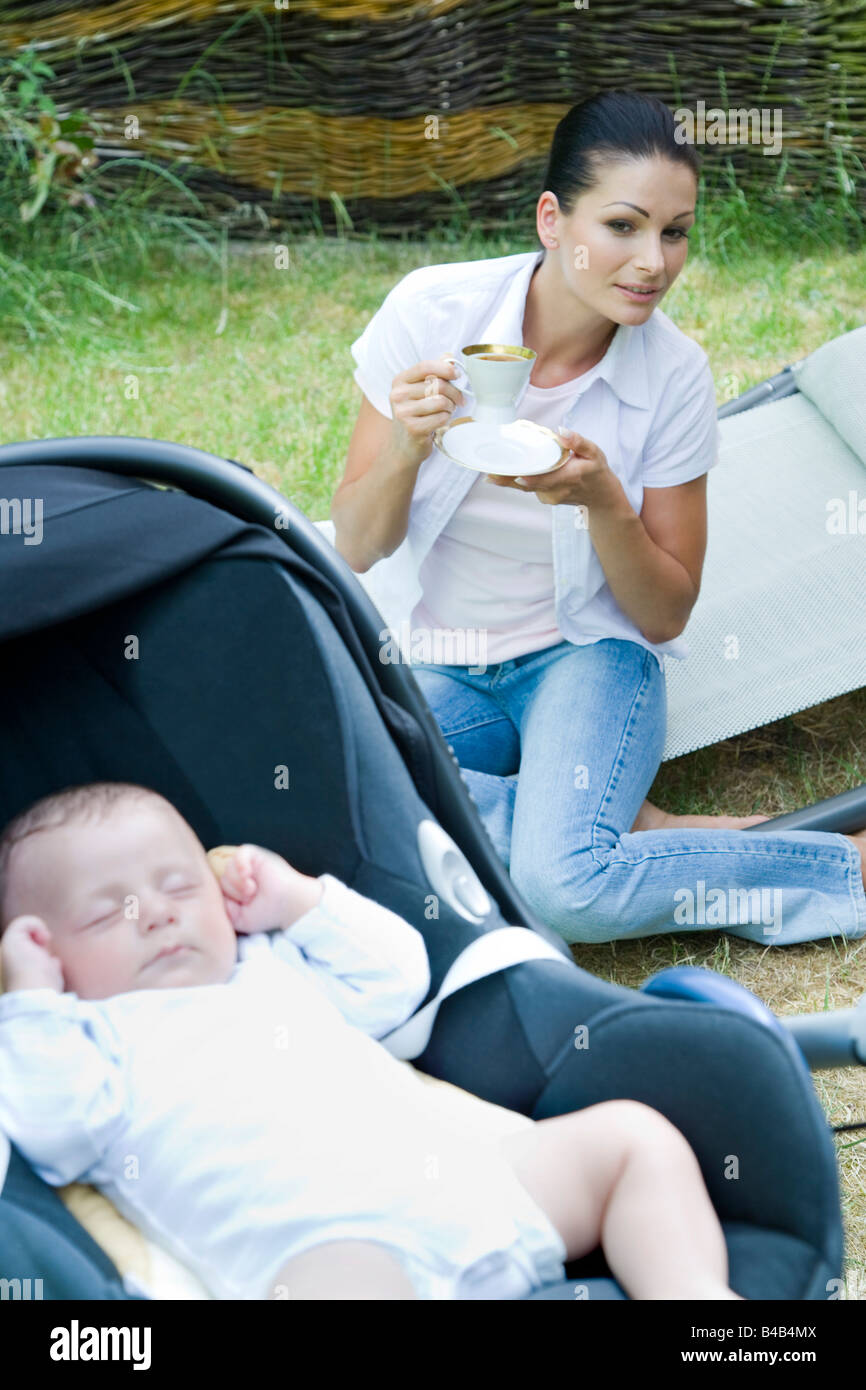 baby sleeping outdoor and mum having coffee Stock Photo - Alamy