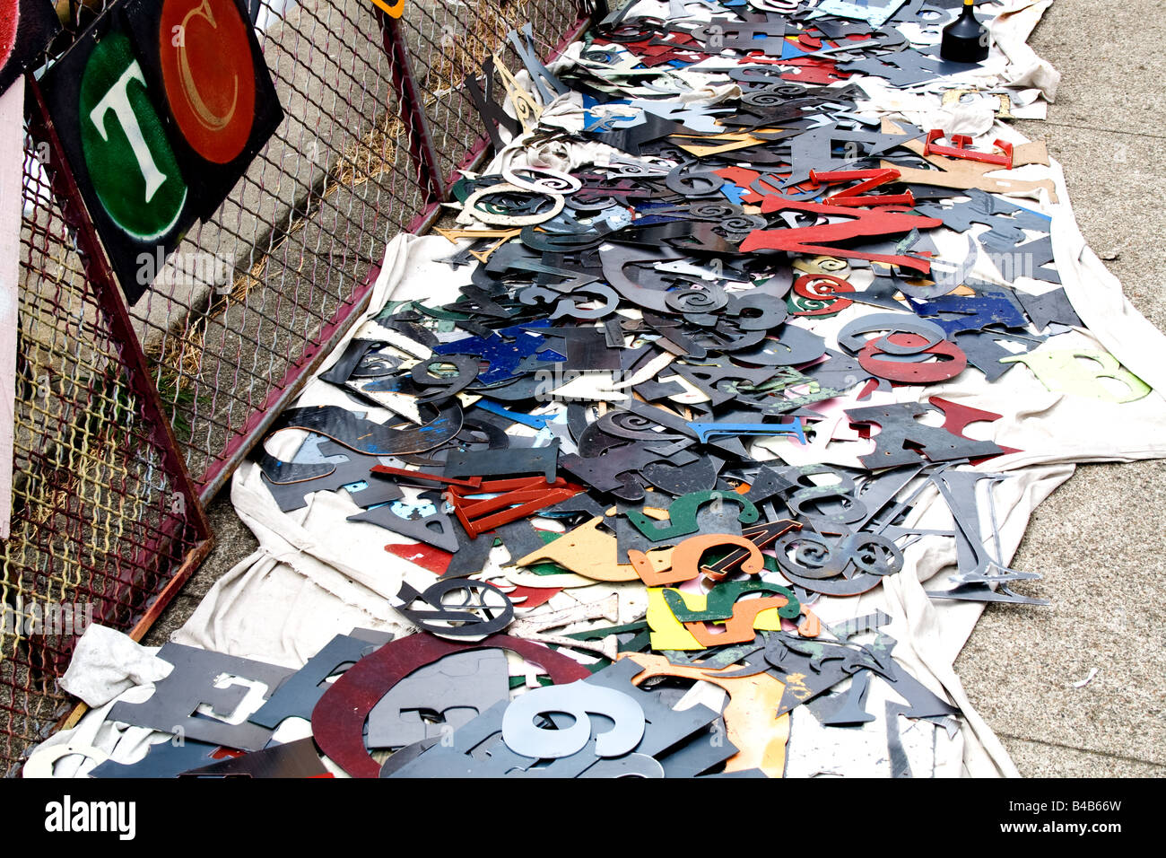 Unordered pile of letters and numbers on a sidewalk Stock Photo - Alamy
