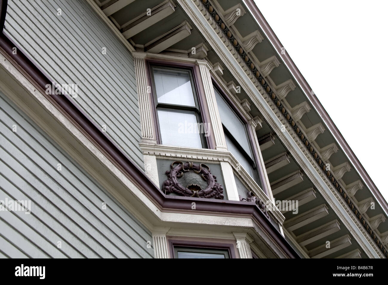 Ornamental window on the side of a gray house Stock Photo - Alamy