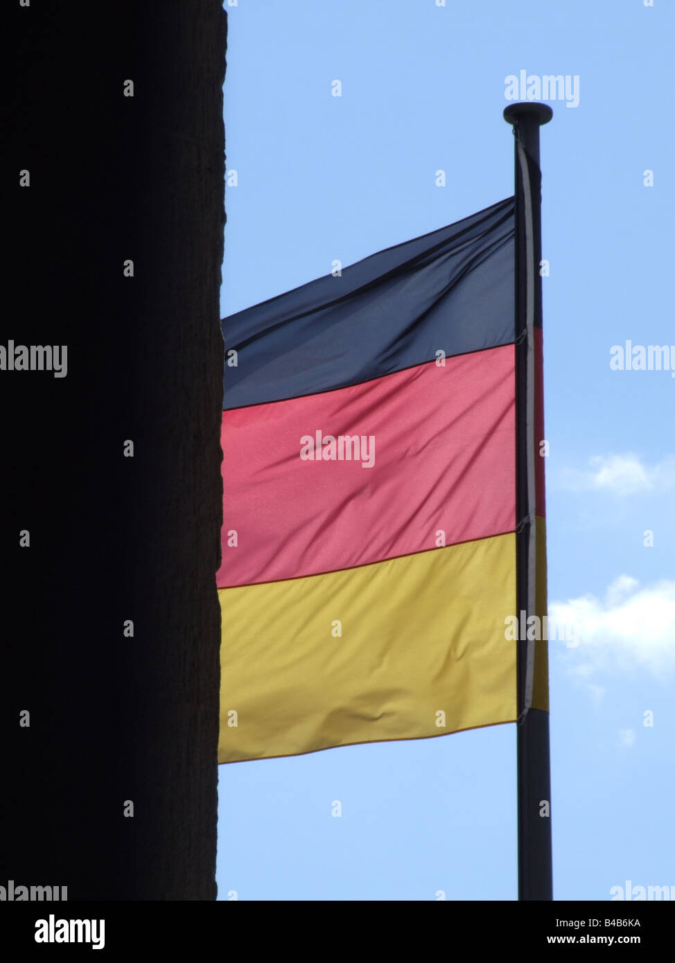 german flag flying in blue sky in berlin Stock Photo - Alamy
