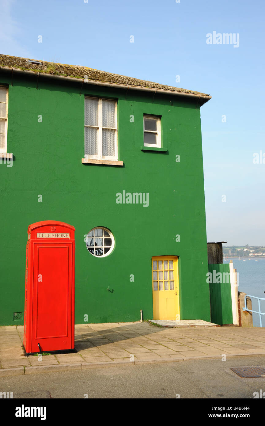 Green House with red telephone box and yellow door by the sea Stock ...