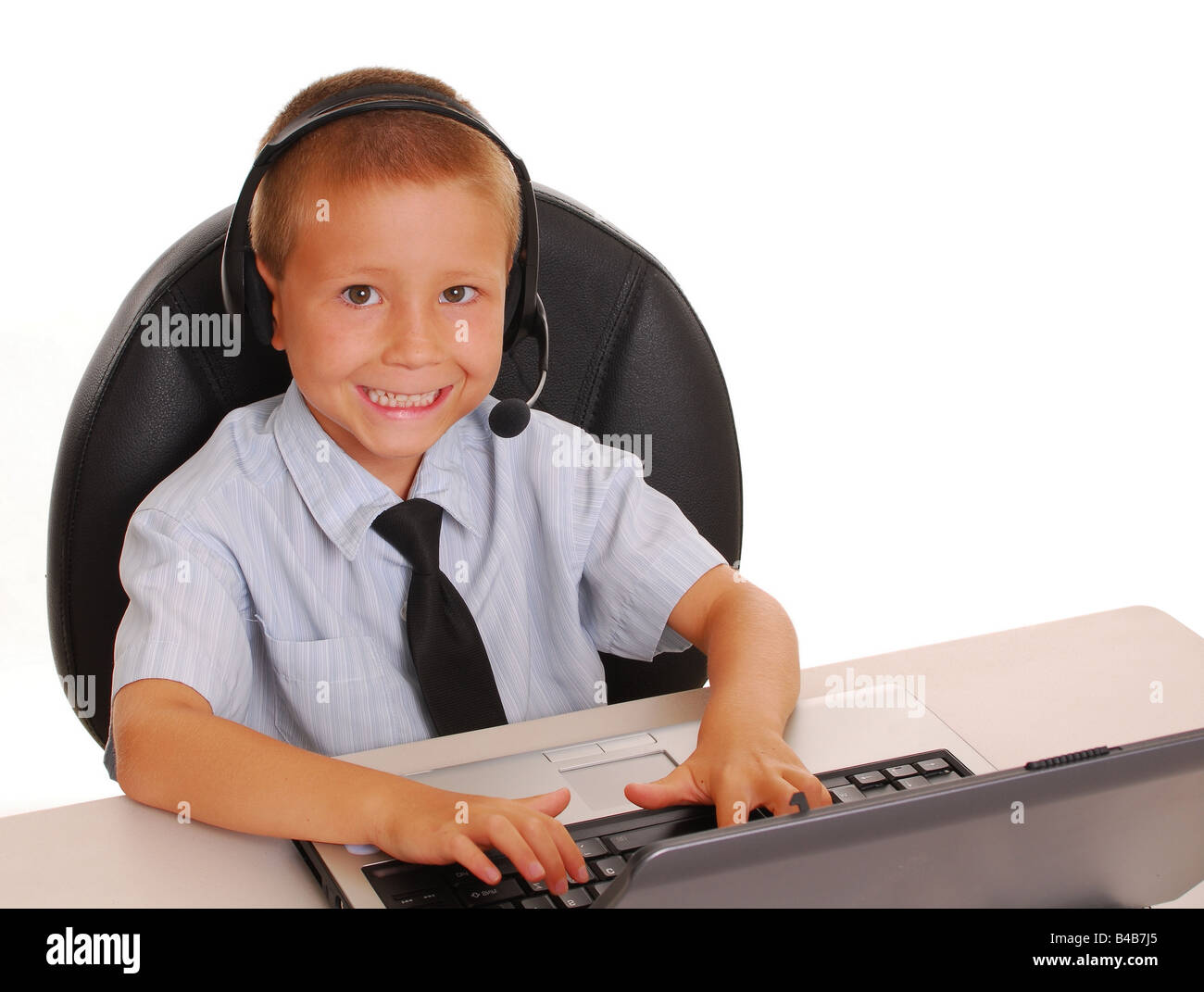 Boy at computer with headset on Stock Photo - Alamy