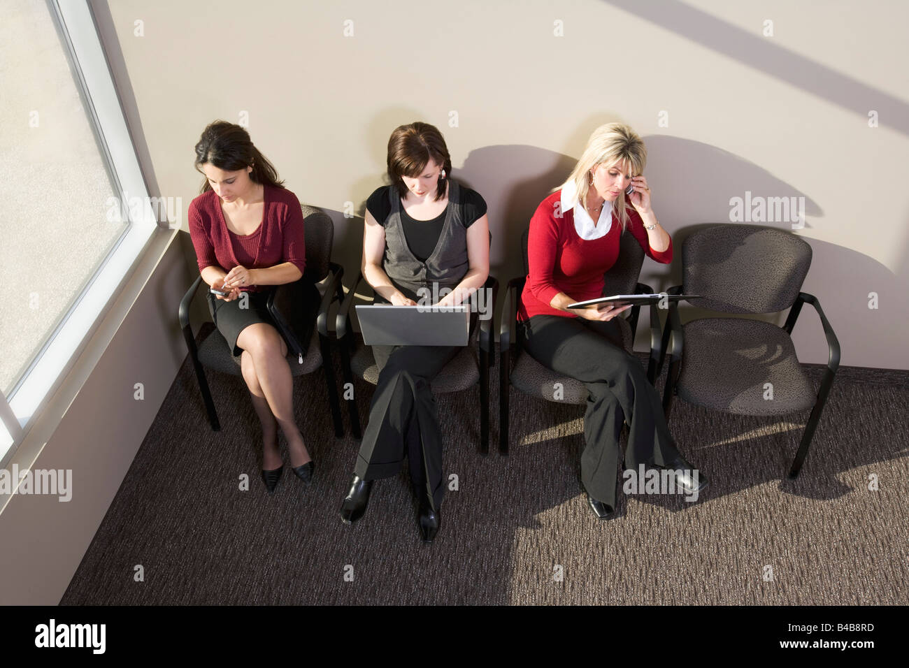 Three women sitting Stock Photo - Alamy