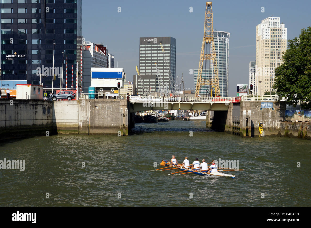 Rowing boat under bridge at river Maas in Rotterdam city center in ...