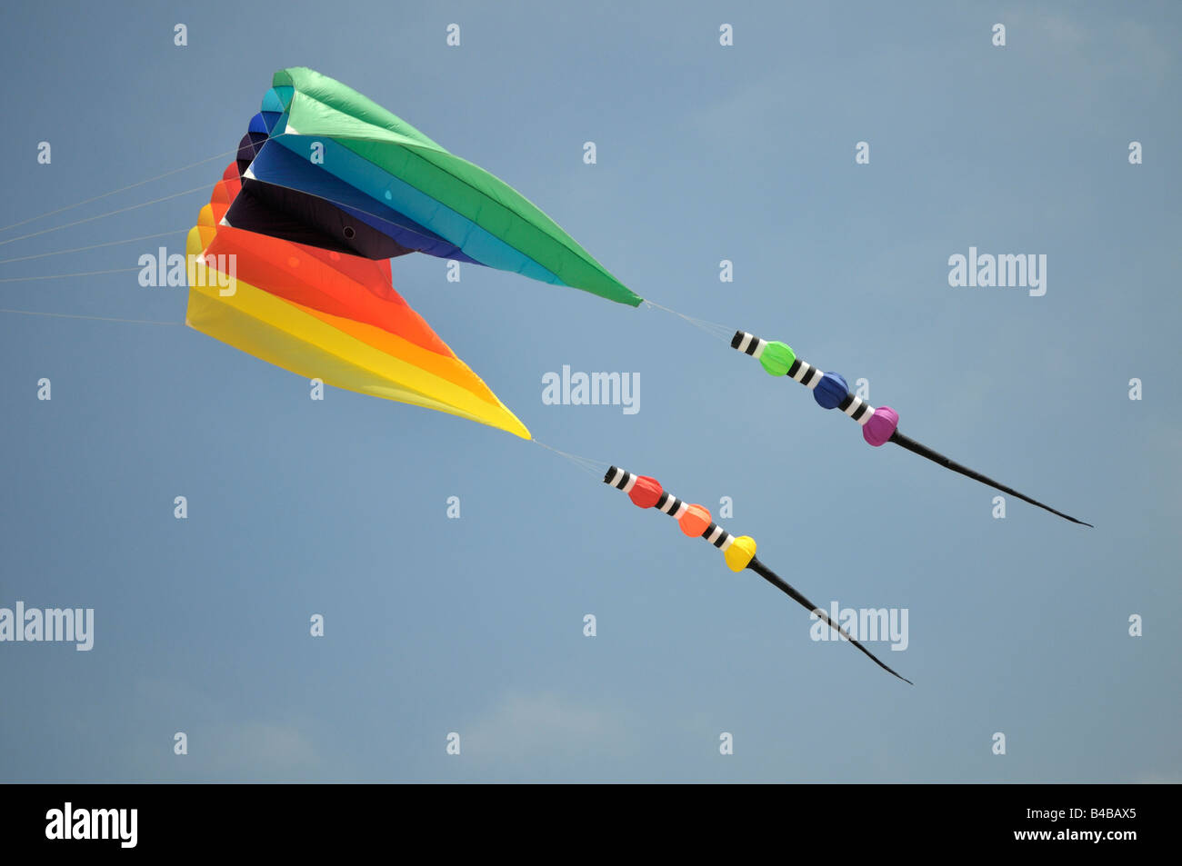 Large colorful kite against a blue sky Stock Photo - Alamy