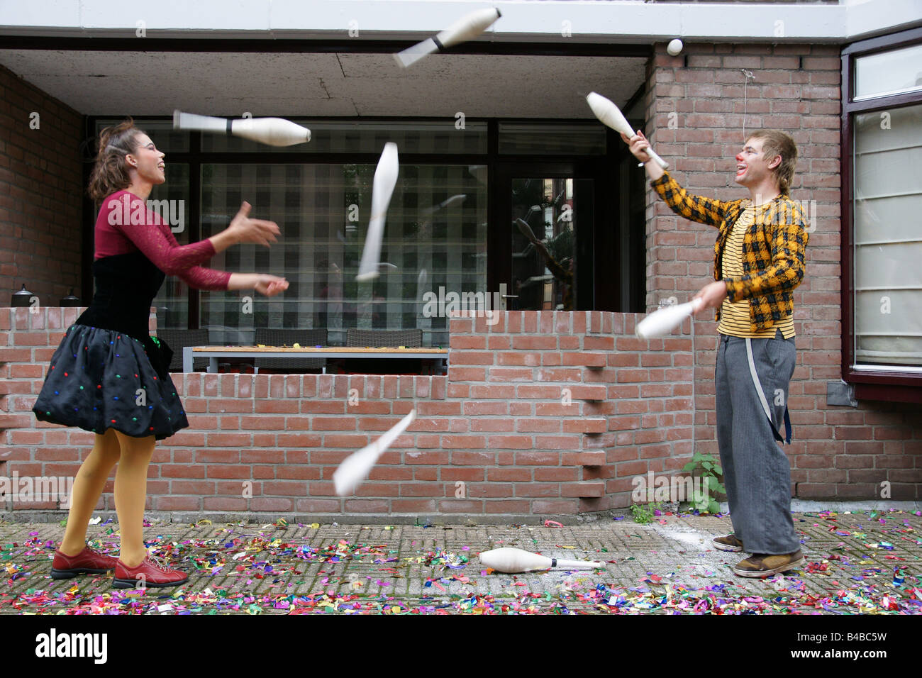 Man and woman jugglers throwing catching playing entertainment trick ...