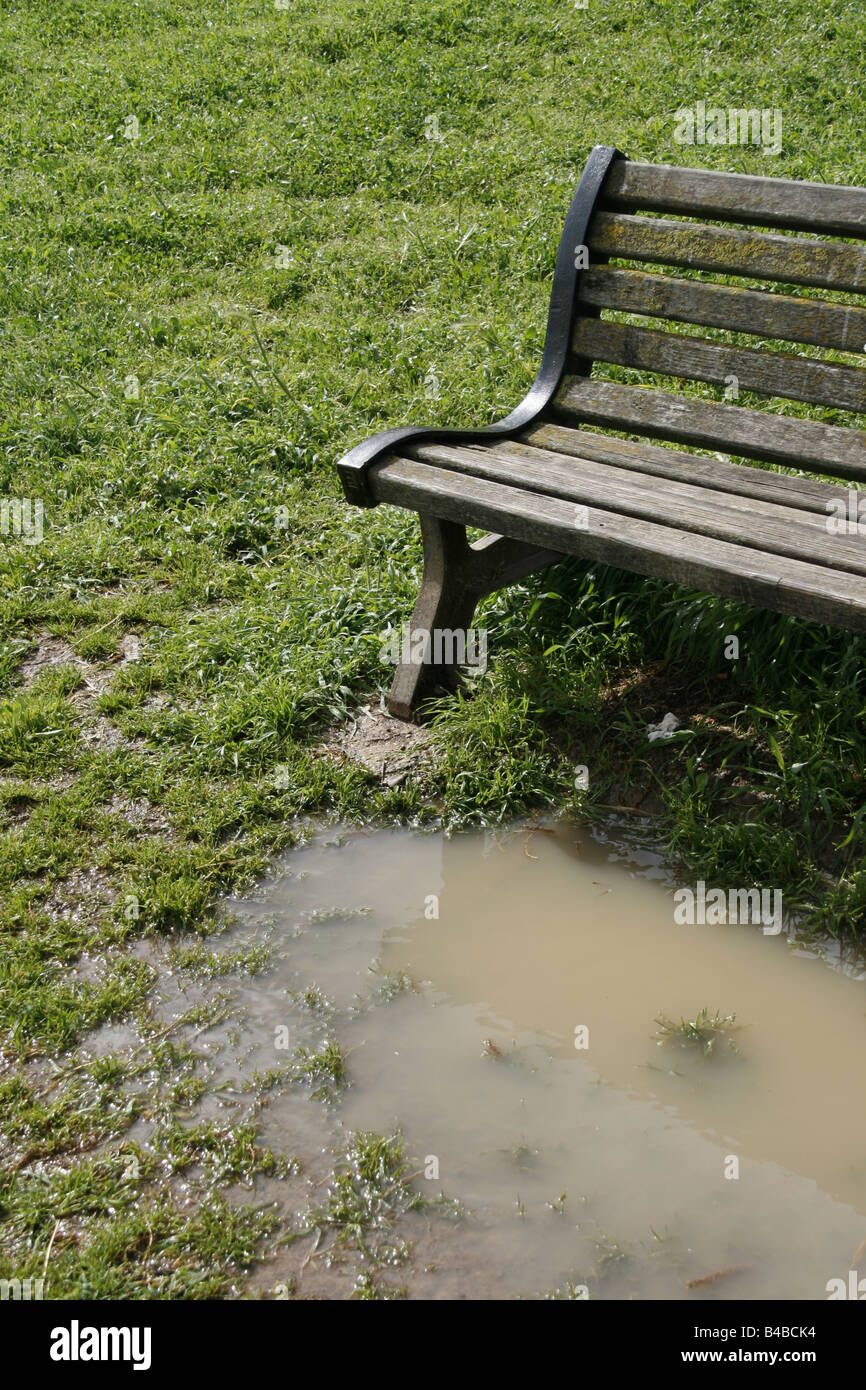 one single wooden bench with flood water in park in countryside Stock ...