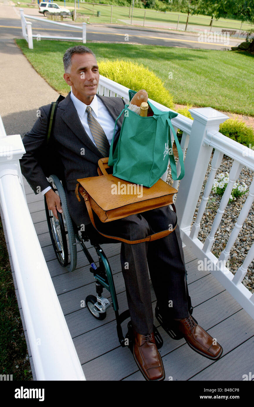 Baby Boomer Aged Businessman in a Wheelchair He is Wearing a Suit and ...