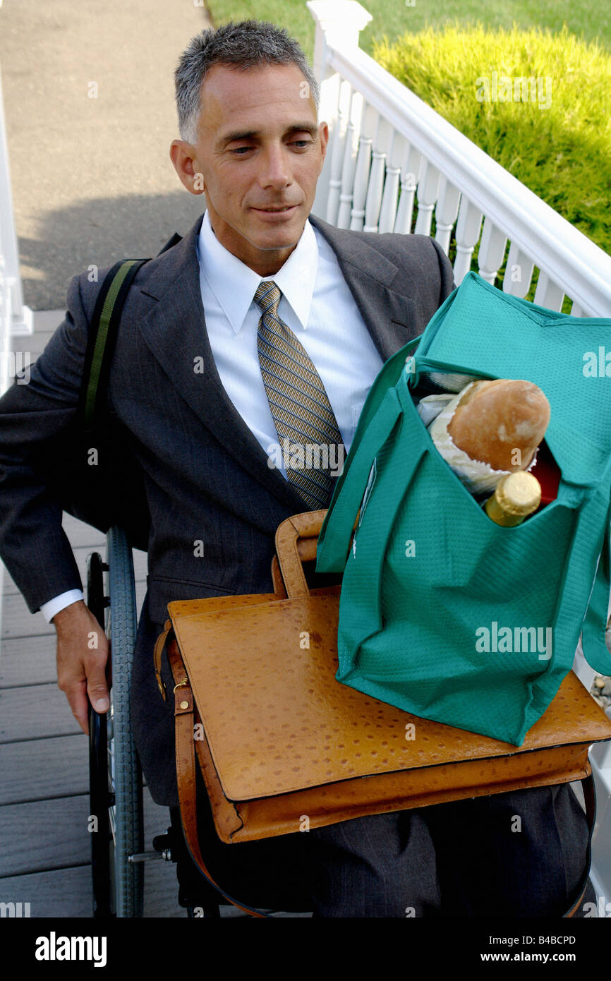 Baby Boomer Aged Businessman in a Wheelchair He is Wearing a Suit and ...