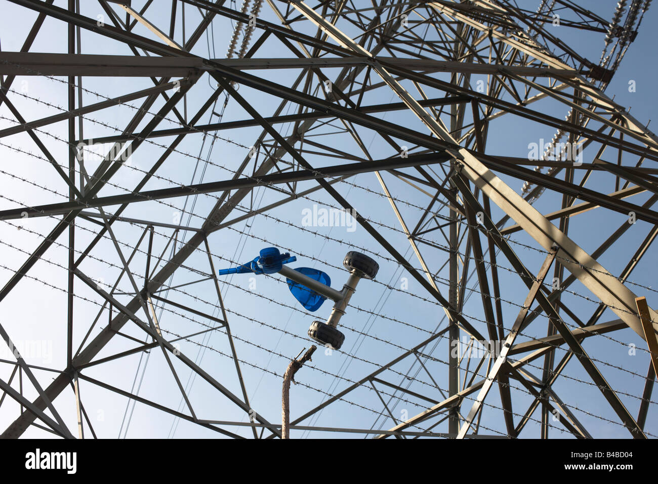Child's tangled tricycle hangs in the barbed wire of an electricity ...