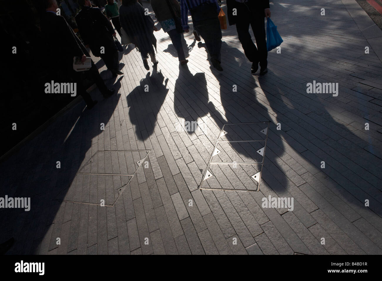 Long commuters' shadows seen across pavement during transport chaos ...