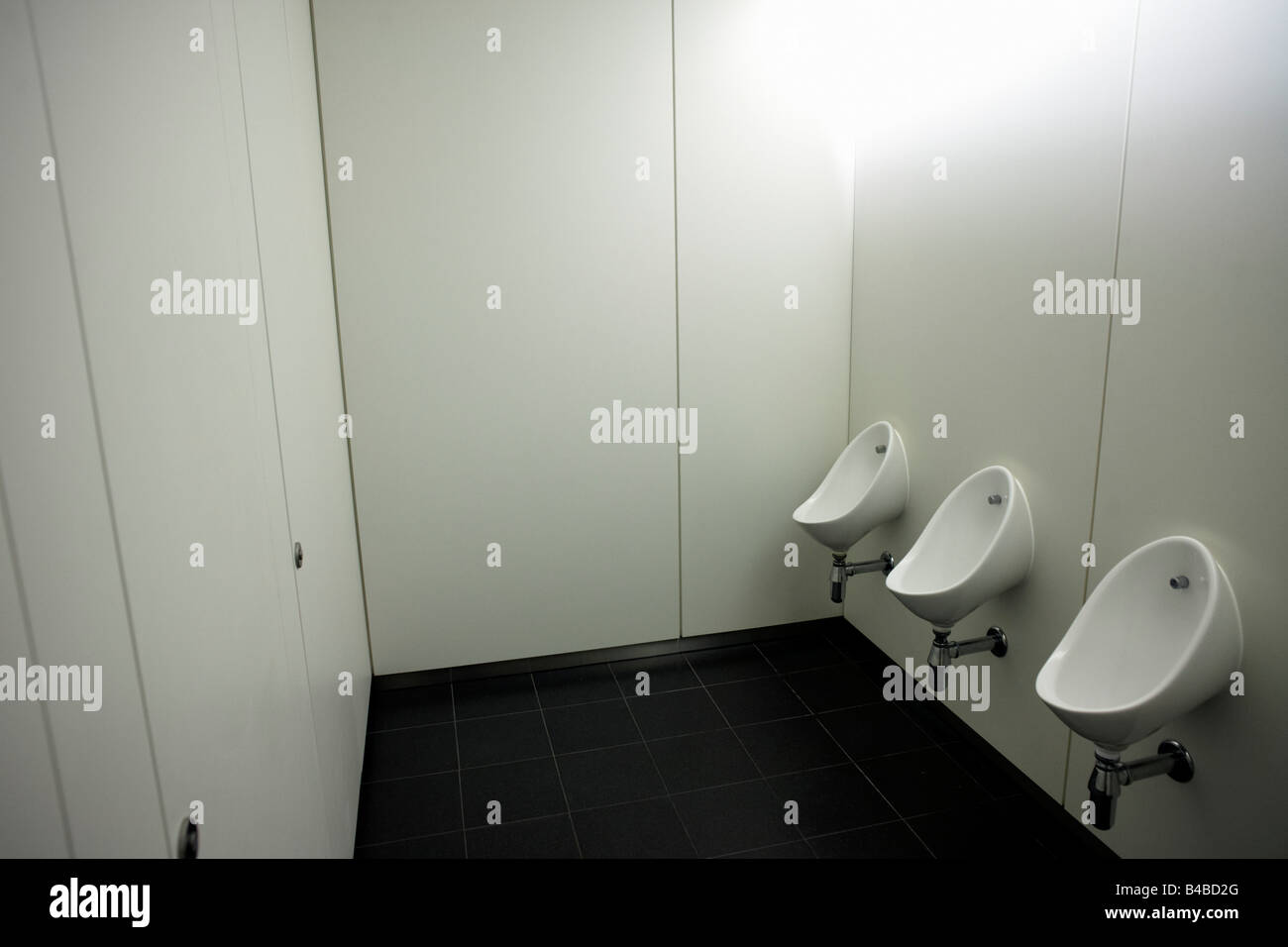 Three clean office urinal toilets at an auditing company's European ...