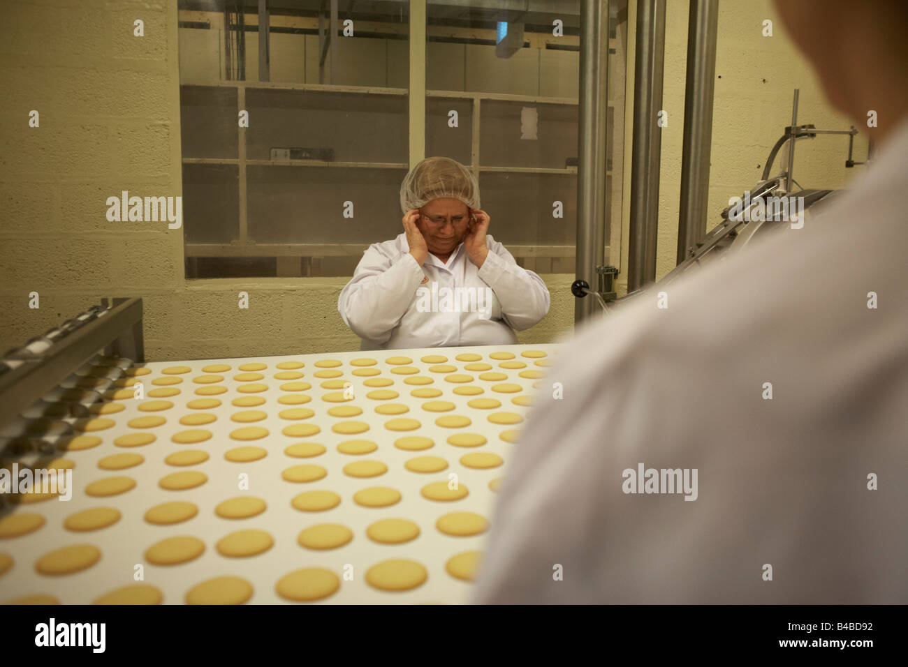 Quality control workers sort through sub-standard Moments biscuits at ...