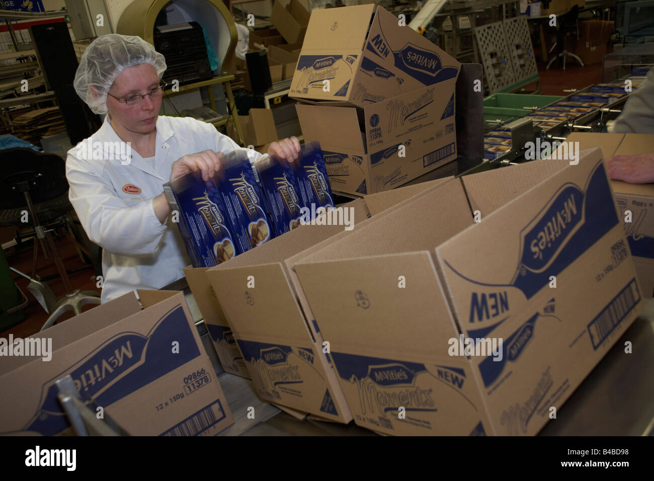 Female employee boxes finished Moments biscuits of at the United ...