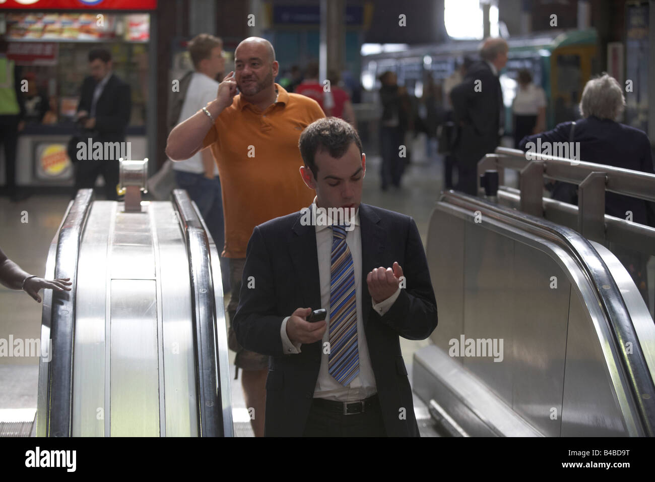 Rush hour train commuters descend by escalator into Underground at ...