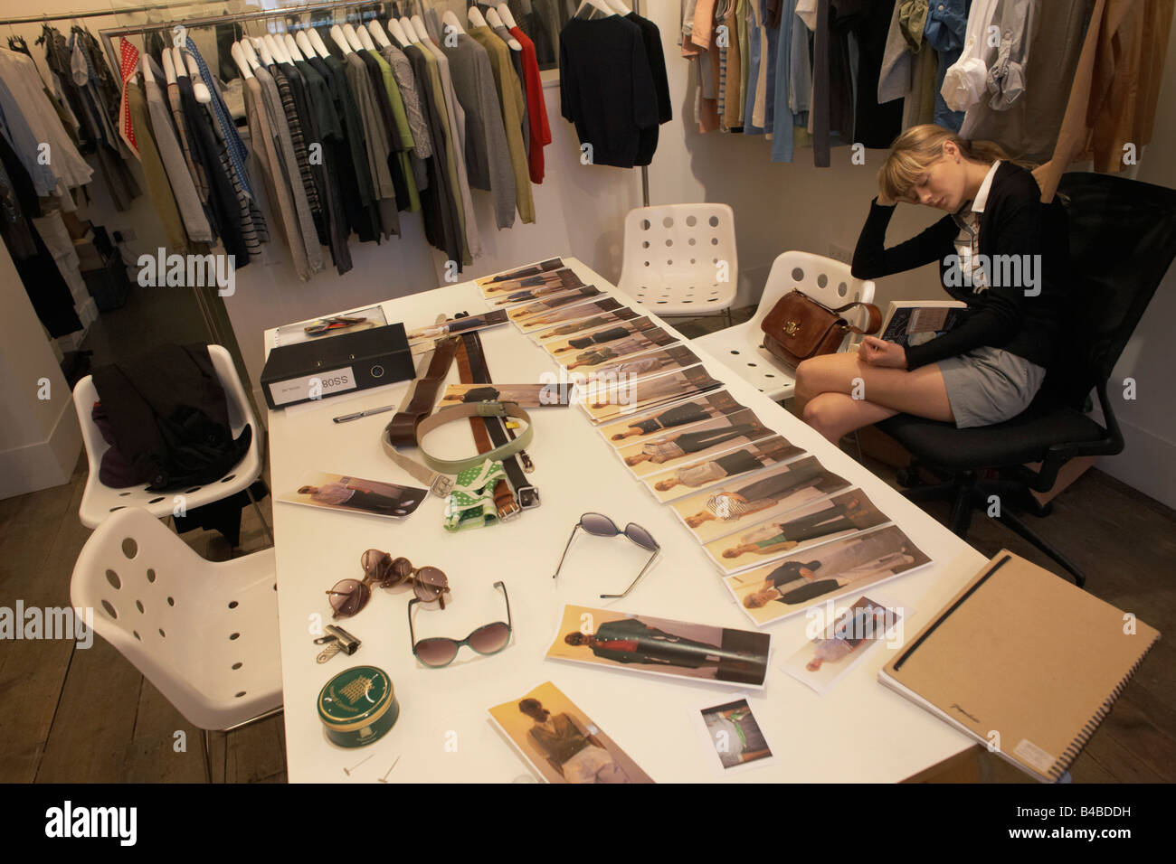 A model waits for more test clothes for the next fashion show at ...
