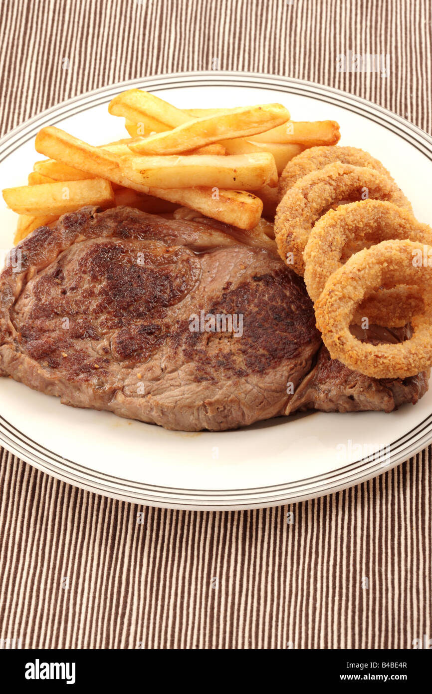 Freshly Cooked Sirloin Beef Steak With Chips And Onion Rings Isolated ...