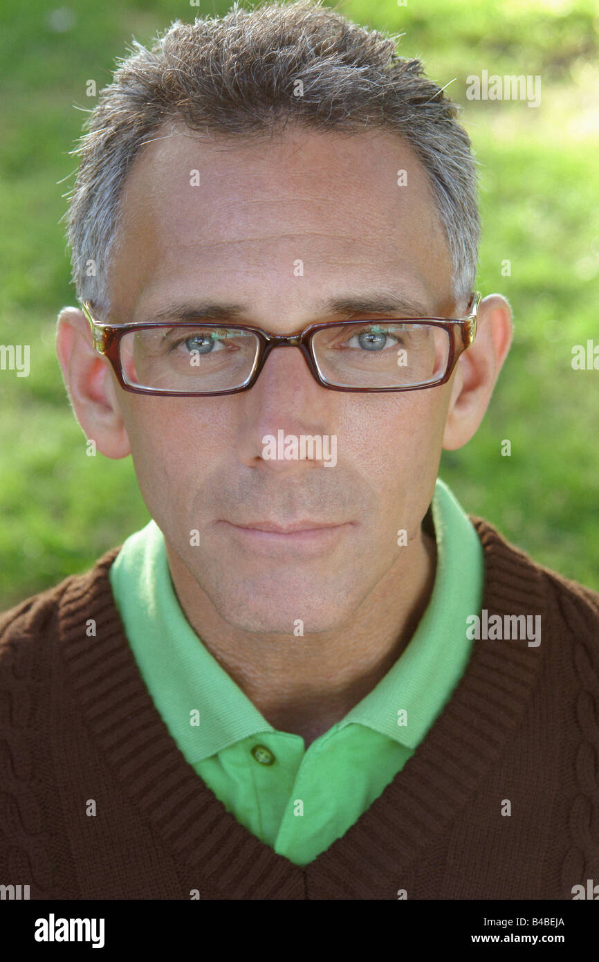 Head and Shoulders Portrait of a Gray Haired Man Wearing Horn Rimmed ...