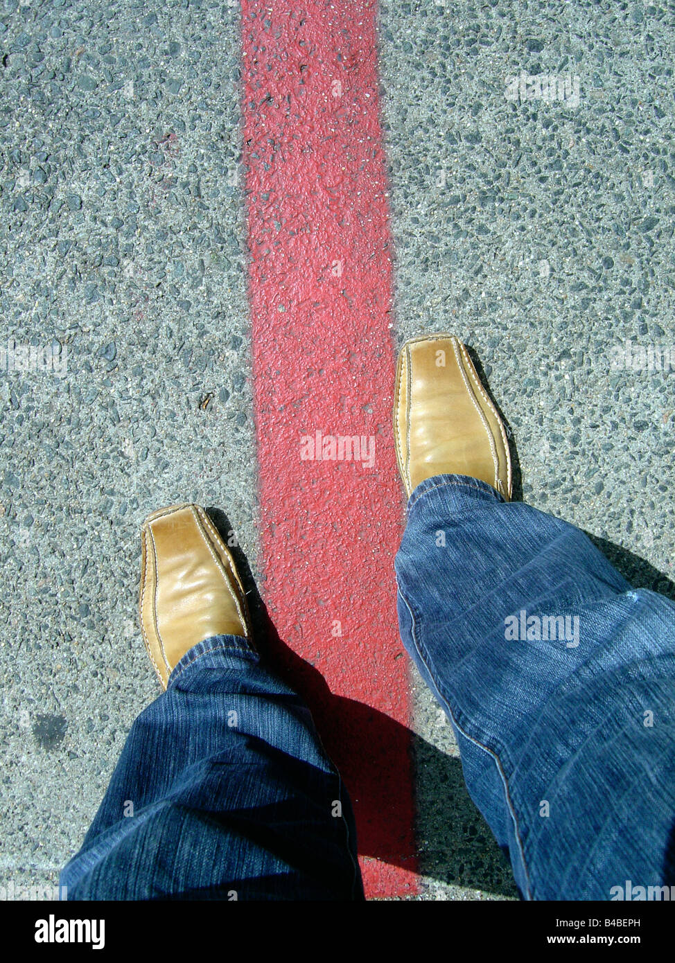 Aerial View of a Man's Feet on a Red Stripe on a Sidewalk as Part of a ...