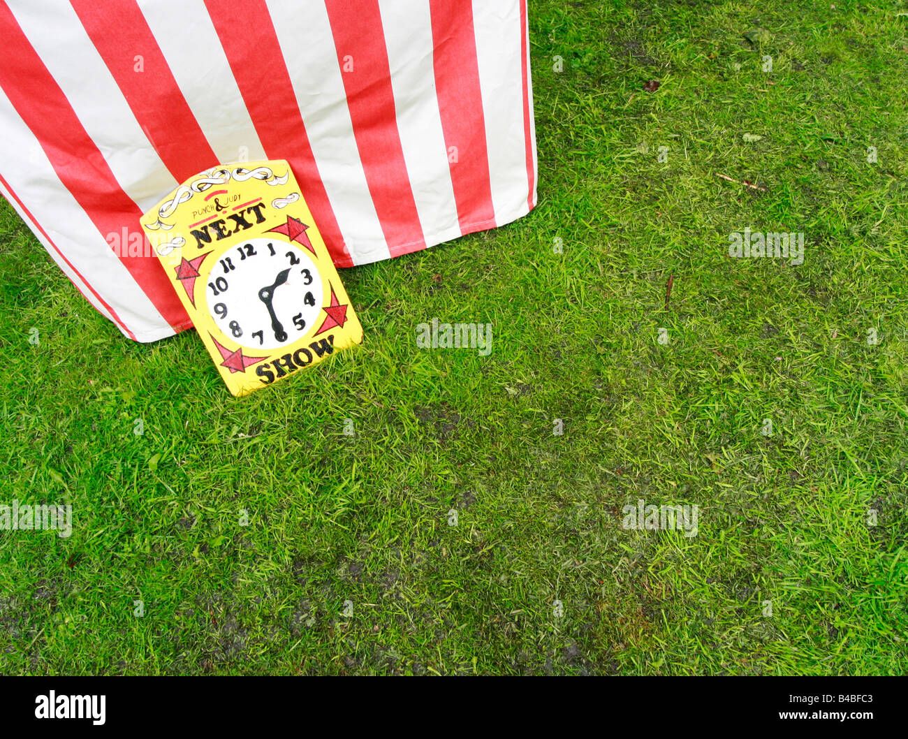 Clock indicating next time a punch and judy show will be held with a ...