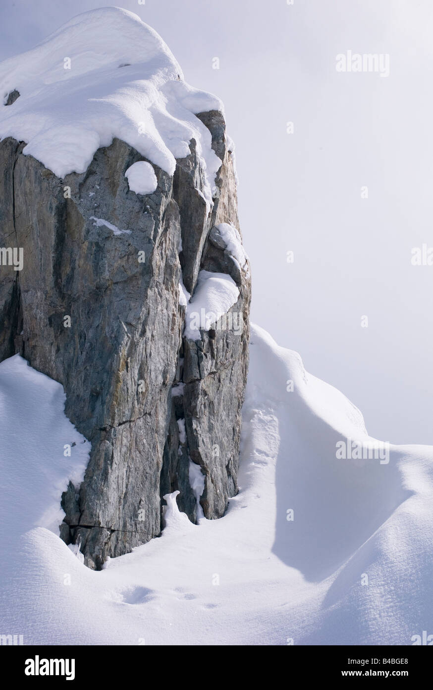 Cliff in the snow Stock Photo - Alamy