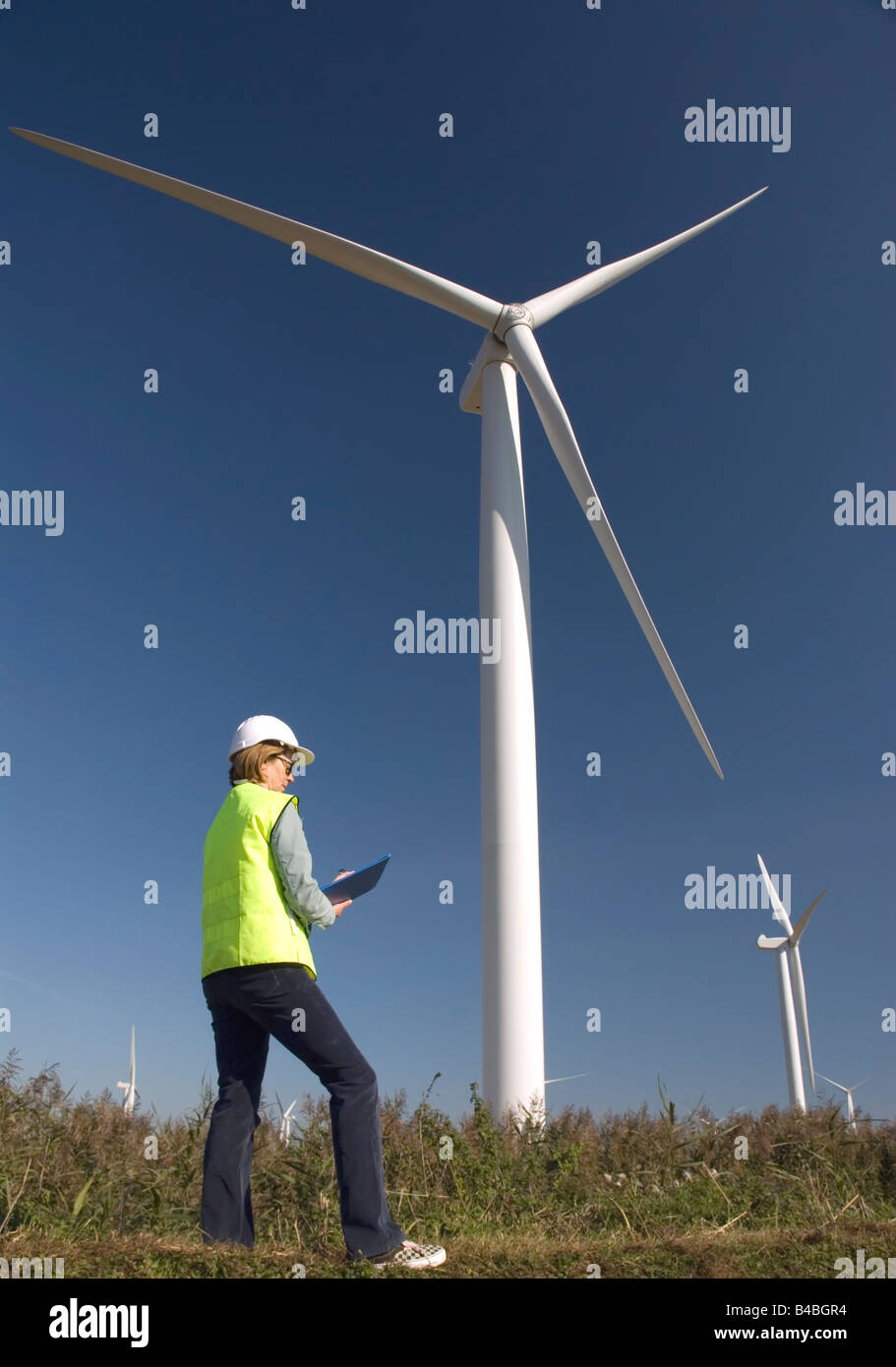 Female engineer next to wind turbine wind farm Stock Photo - Alamy