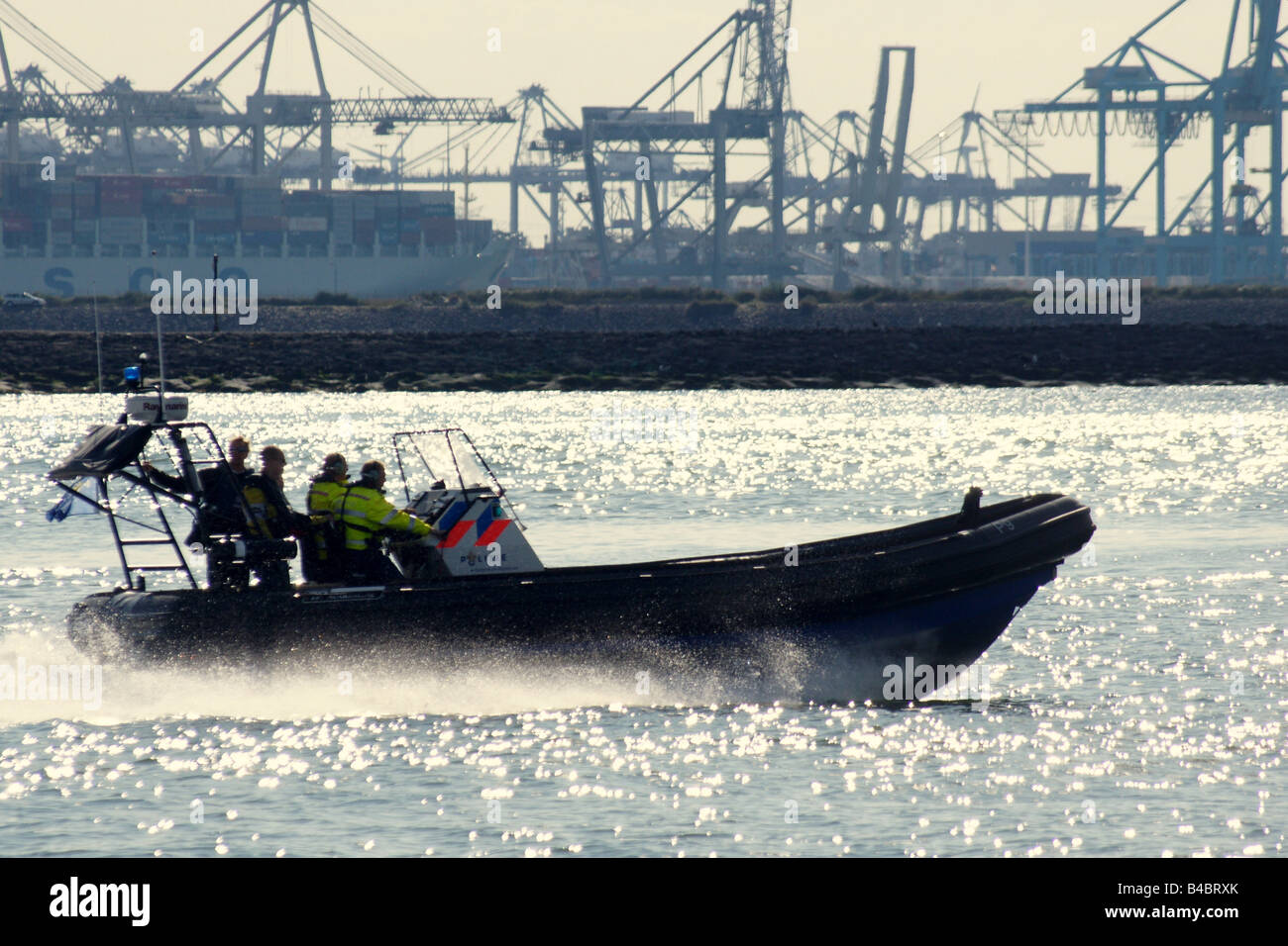 Speedboat boat running fast water sea with Europoort port harbour in ...