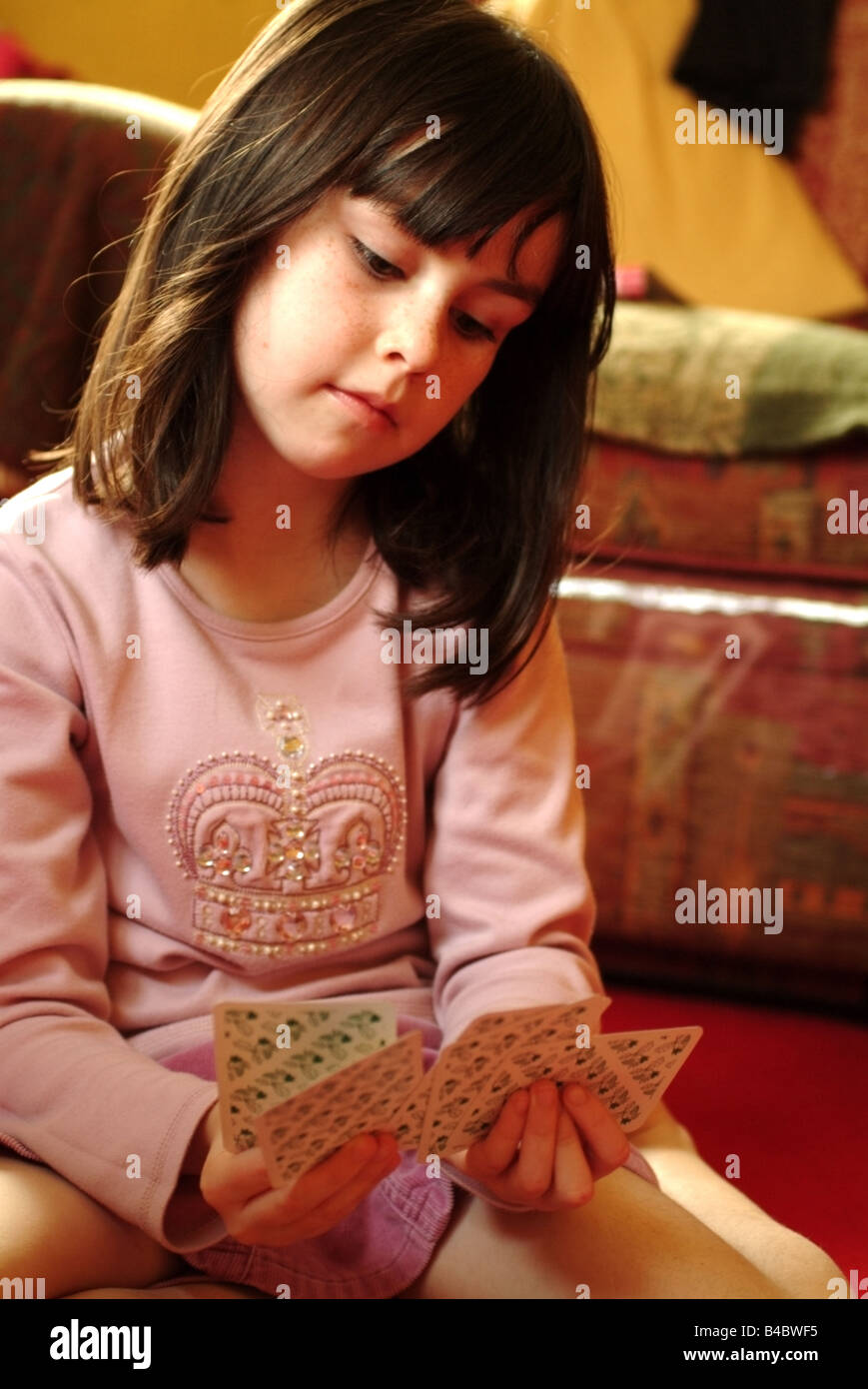 A girl playing cards Stock Photo - Alamy