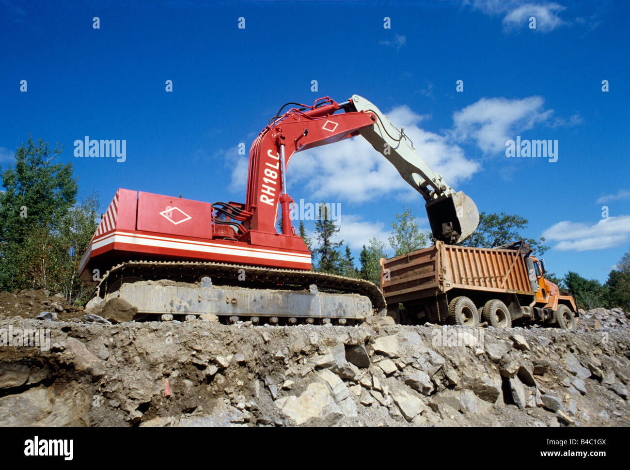 excavator loading dump truck Stock Photo - Alamy