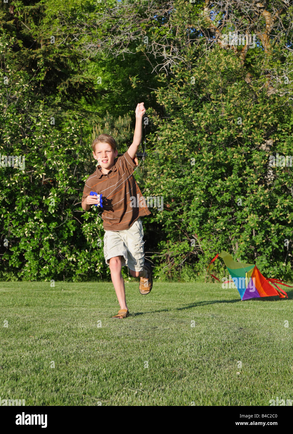 young boy attempting to fly a kite Stock Photo - Alamy