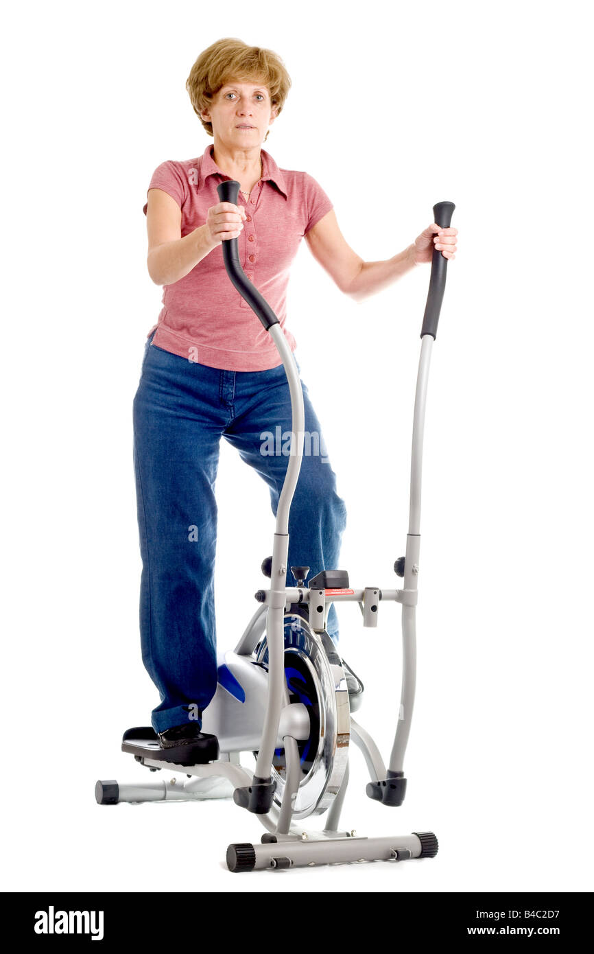 woman exercising on an elliptical stationary bicycle Stock Photo - Alamy