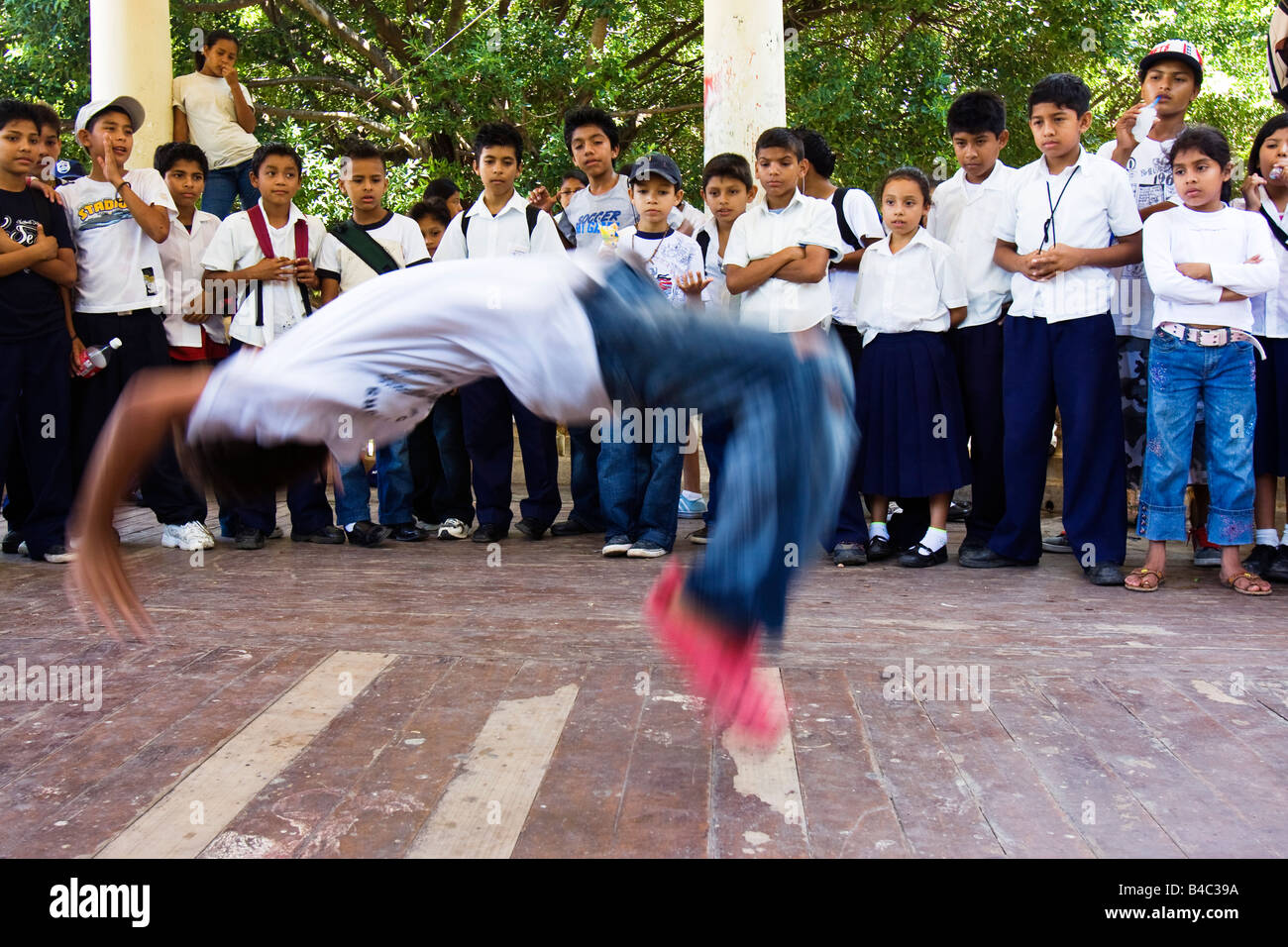 School children watch a break dancing and back flipping display in the ...