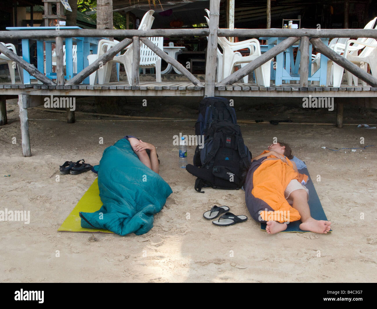 Two guys sleeping rough on the beach Stock Photo - Alamy