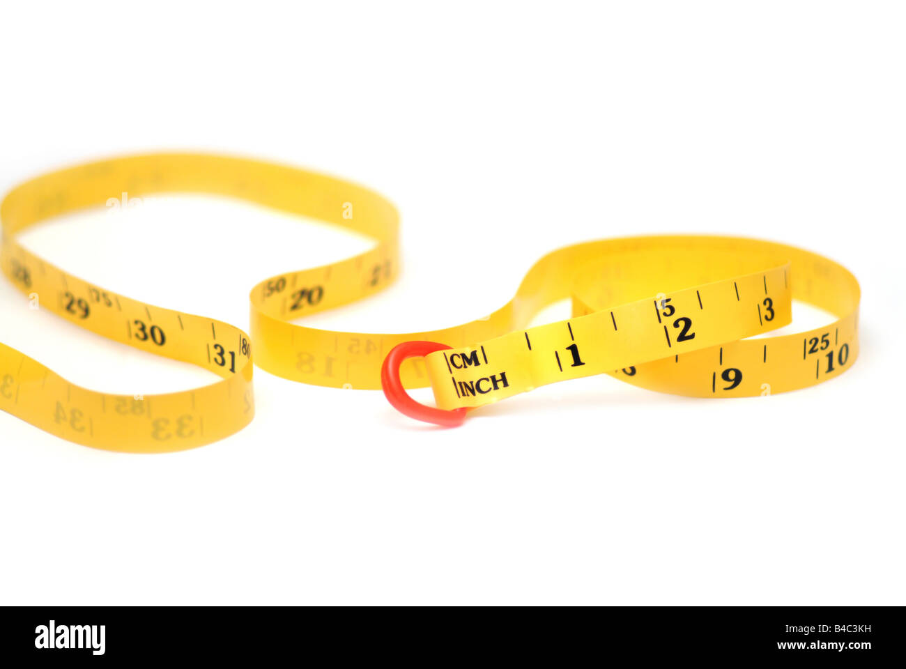 yellow measurement tape isolated on a white background Stock Photo - Alamy