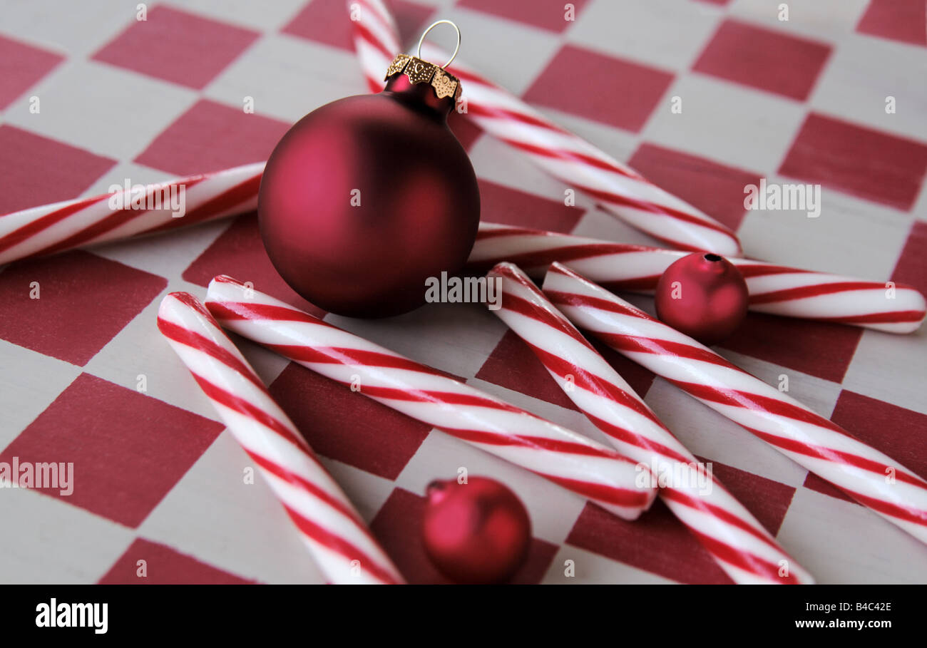 peppermint sticks and a red ornament on a stenciled checkerboard Stock ...