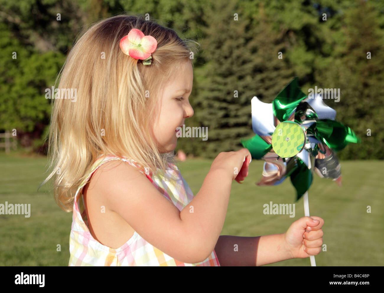 young girl playing with a pinwheel outdoors Stock Photo - Alamy