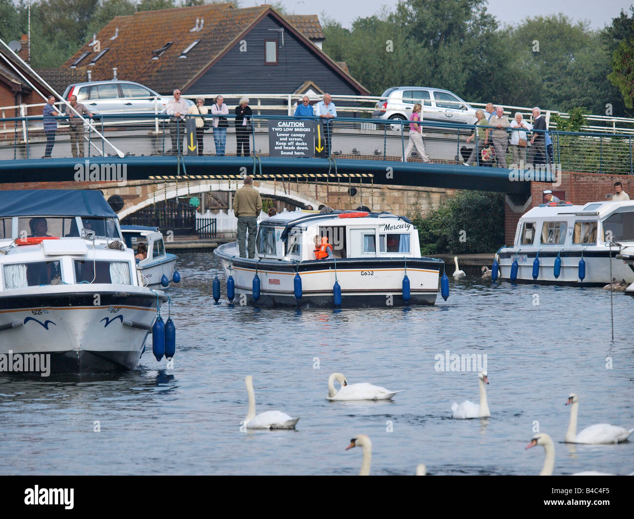 PLEASURE CRUISER GOING UNDER ROAD BRIDGE AT WROXHAM NORFOLK EAST ANGLIA ...