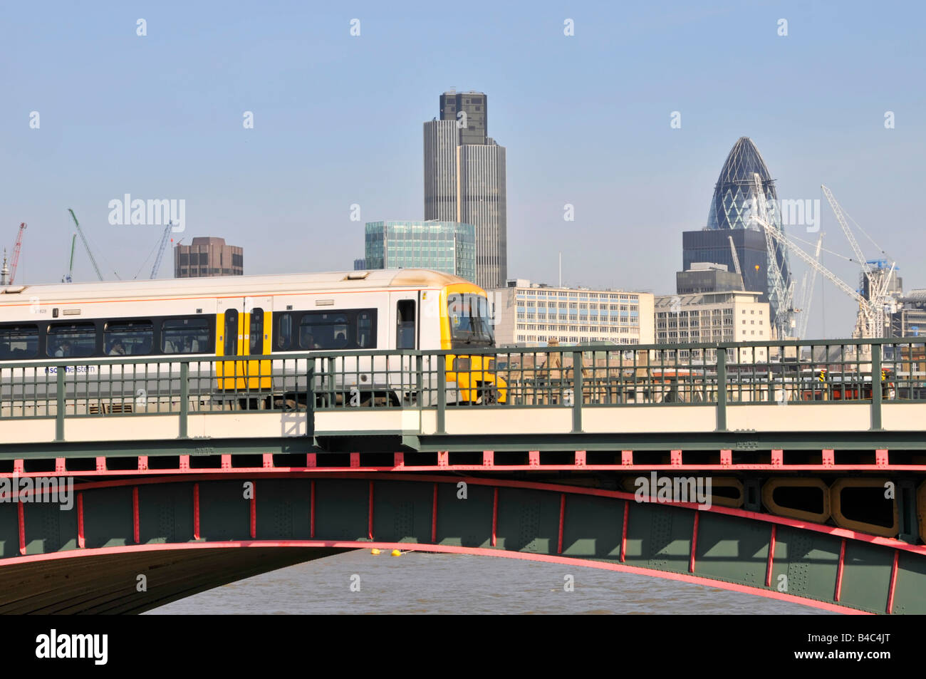 Blackfriars railway bridge crossing River Thames with public transport ...