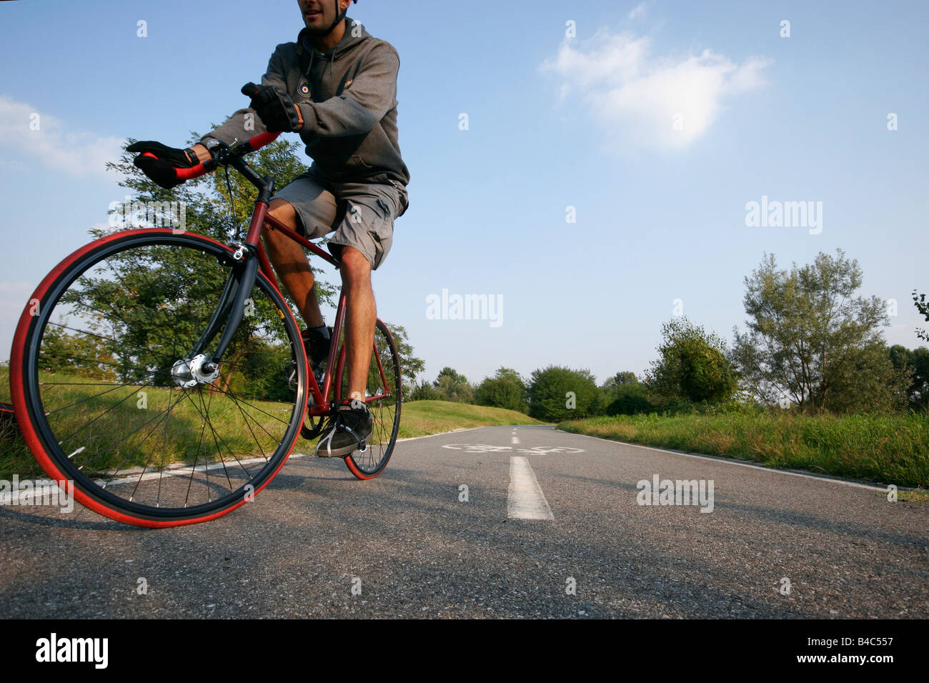 Boy rides his red bike on a cycleway Stock Photo - Alamy