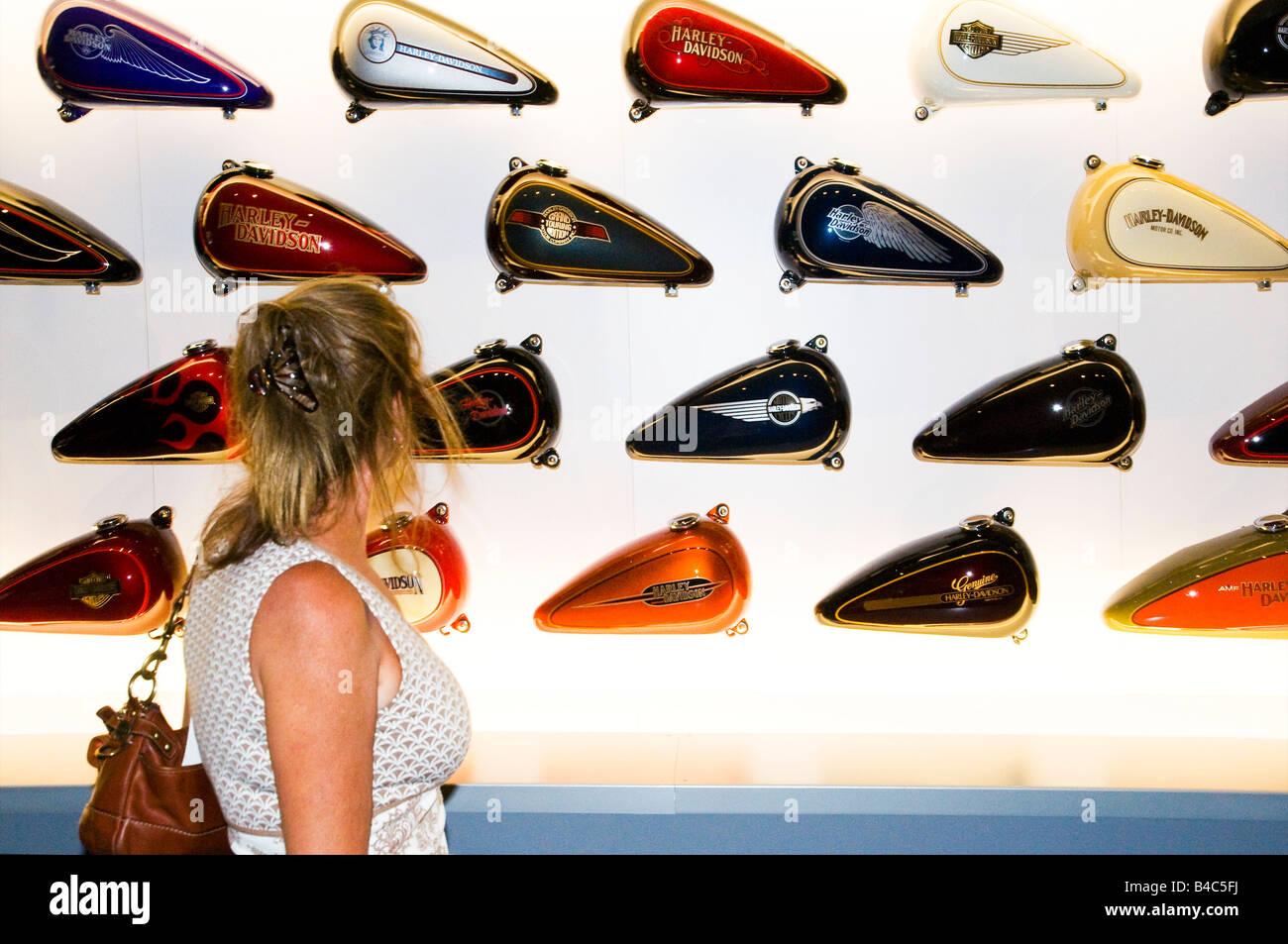 Woman viewing gas tank graphics on display at the new Harley-Davidson ...