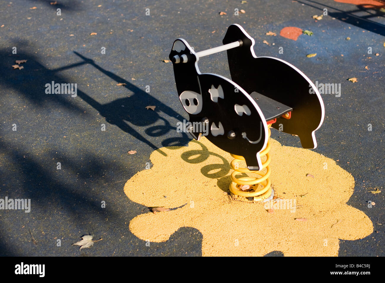 Cow spring rider in a childrens playground Stock Photo - Alamy