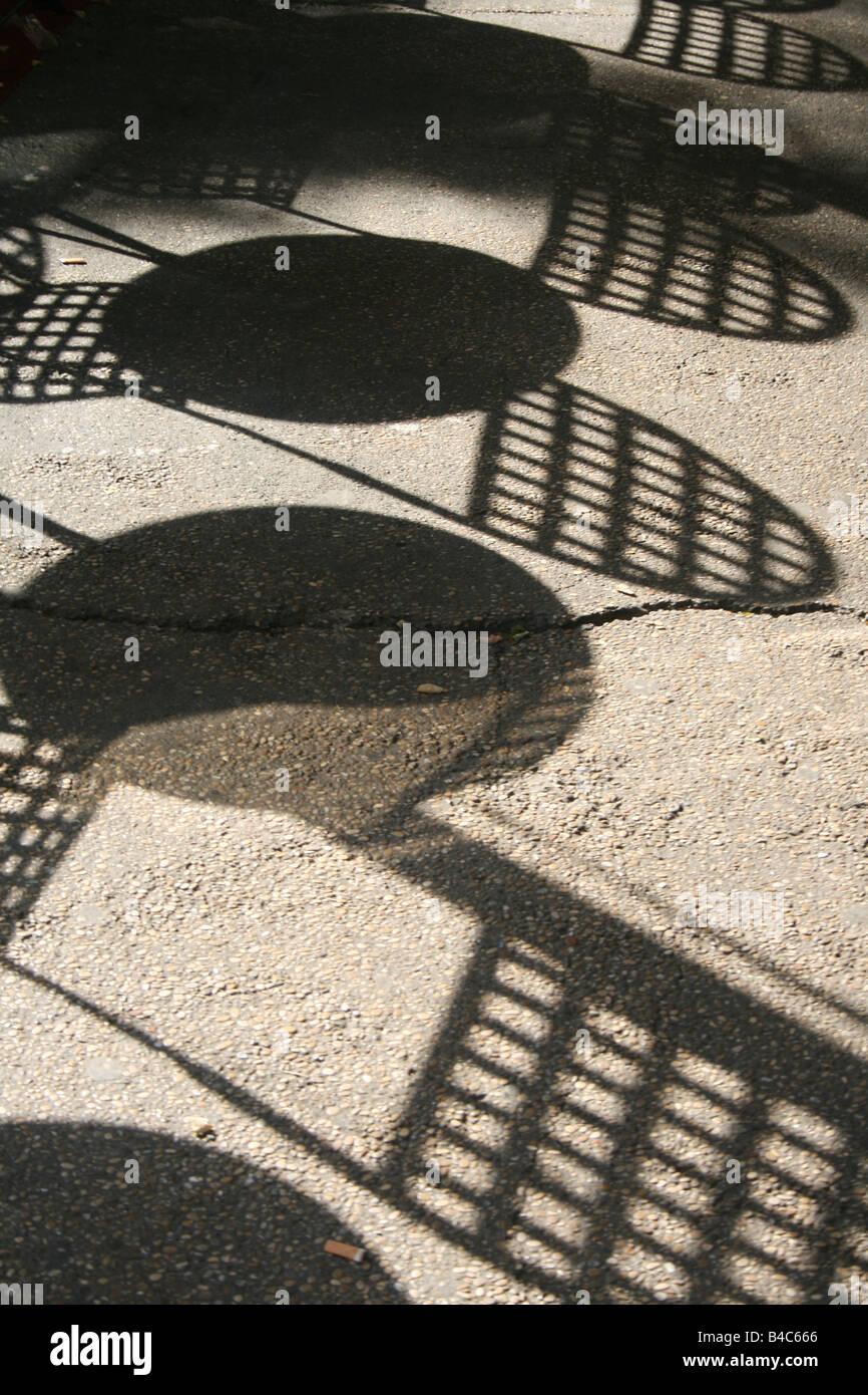 row of chairs shadow on street road Stock Photo - Alamy