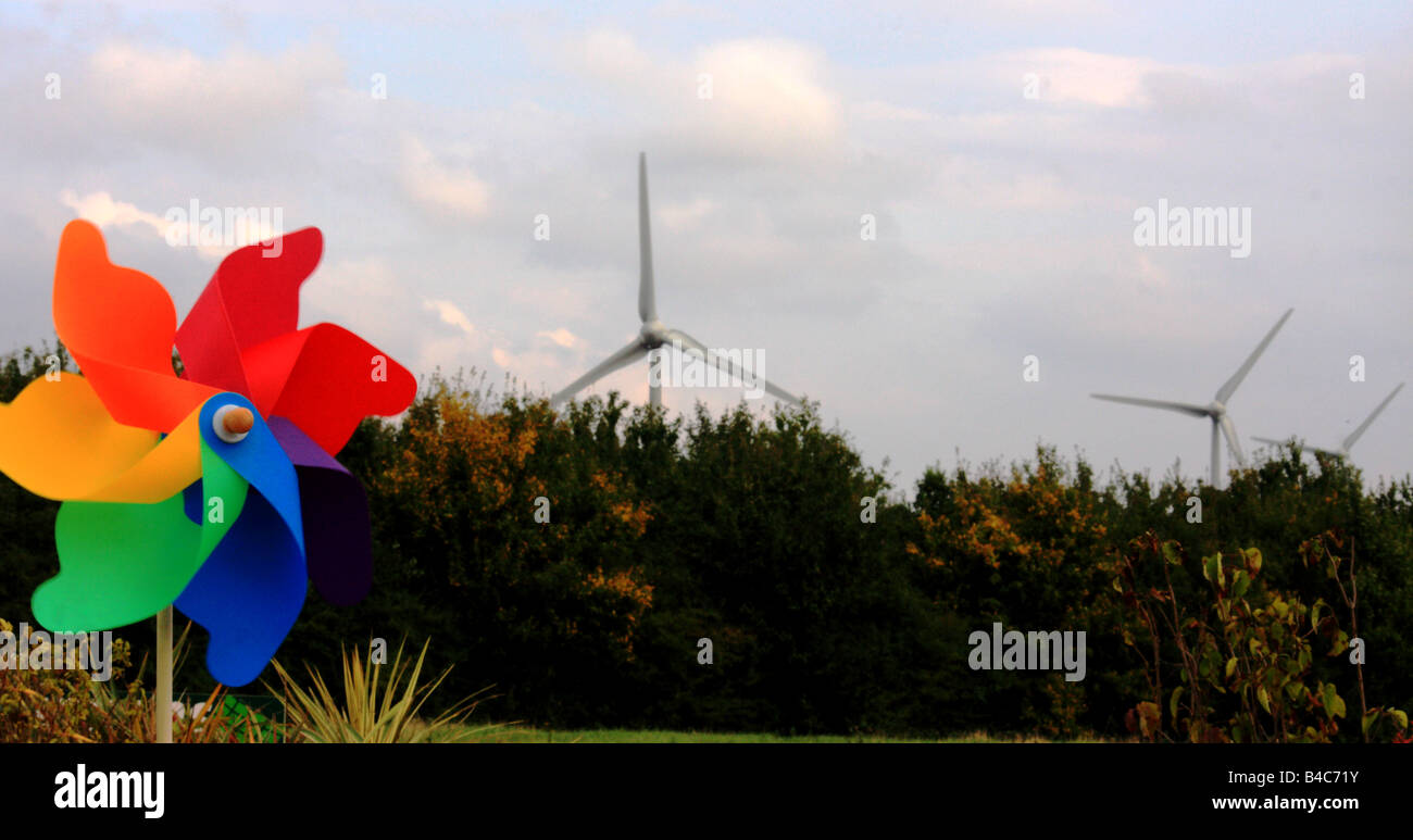 A child's colourful toy windmill with large wind turbines in the ...