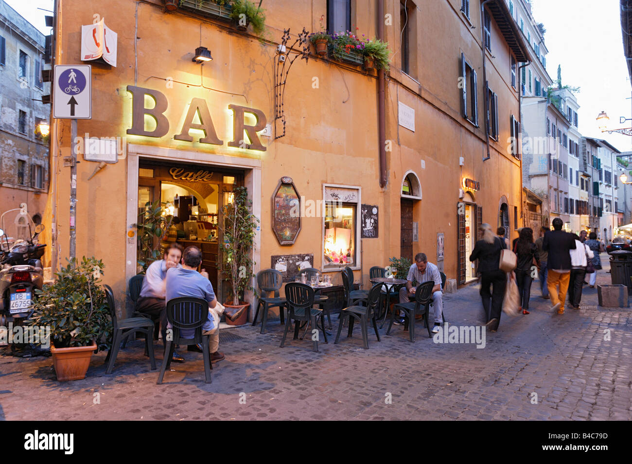 Guests sitting outside a bar in the evening evening Trastevere Rome ...