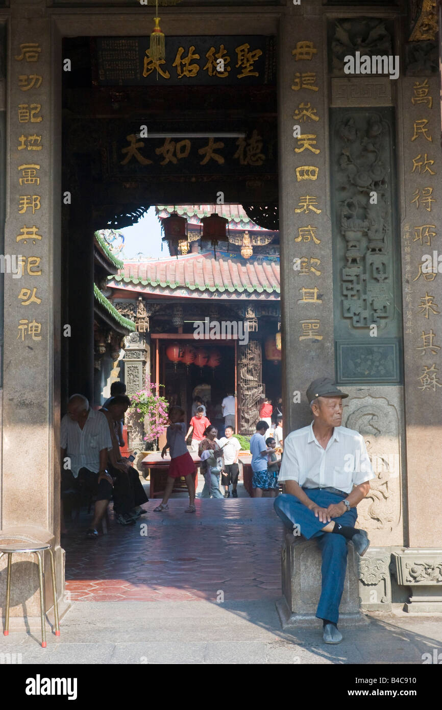 Elderly male seated at entrance to Tian Ho Temple, Lugang, Changhua ...