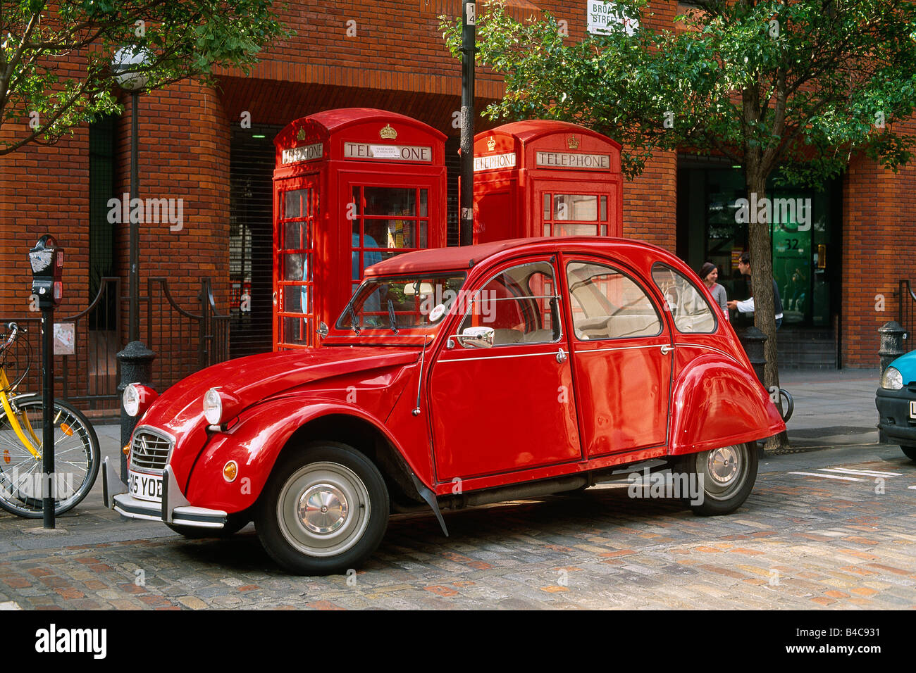 Great Britain - London - red vintage car parked by telephone booths ...