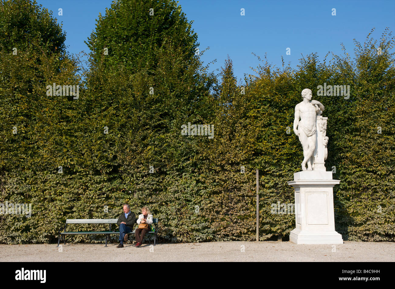 people sitting on a bench in Palais de Schonbrunn Vienna Austria Stock ...