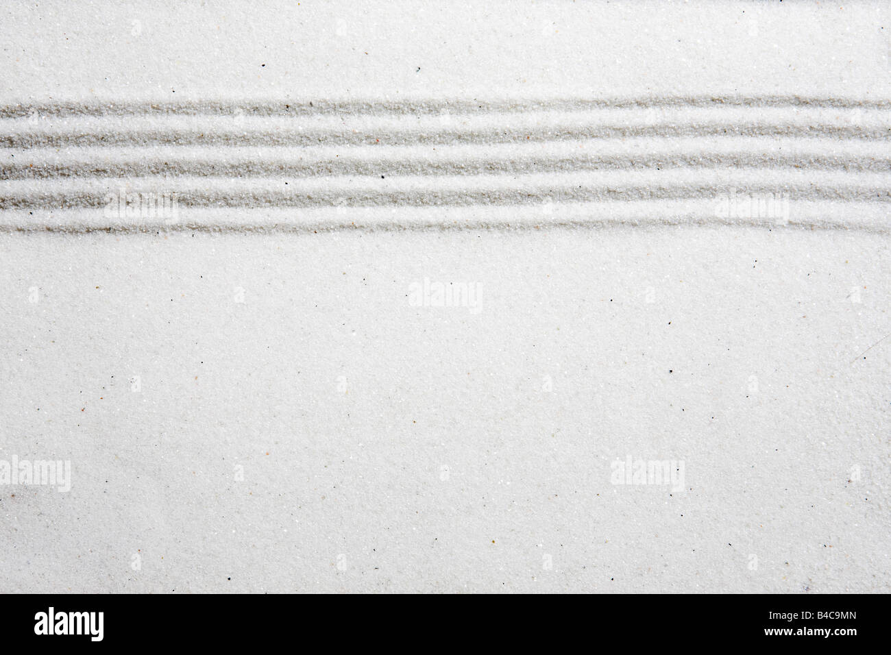 A background image with white sand and a raked stripe Stock Photo - Alamy