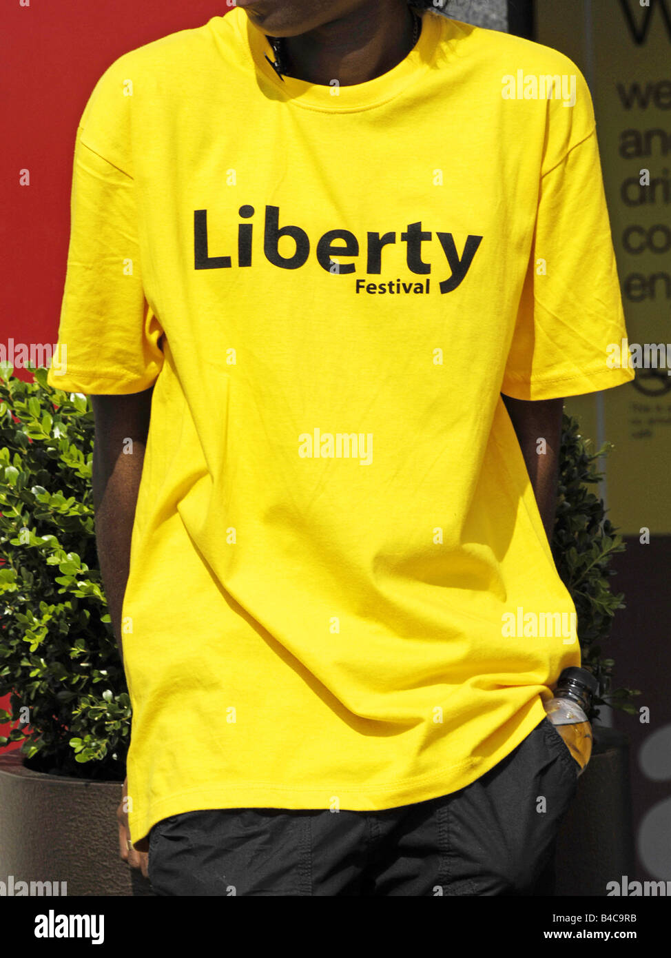 Bright yellow t shirts worn by black female steward at the Liberty ...